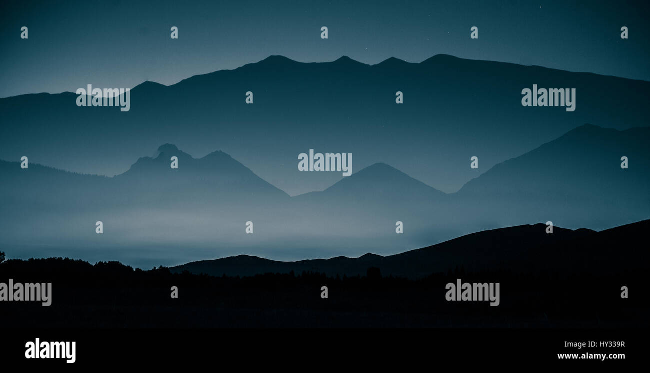 A beautiful, abstract monochrome mountain landscape in blue tonality ...