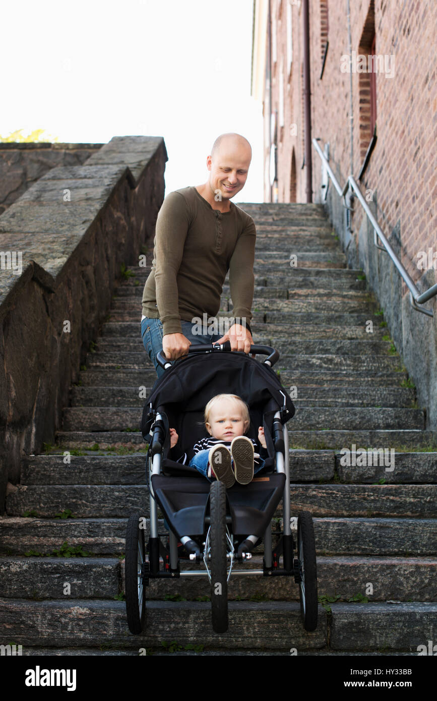 Boy pushing stroller hi-res stock photography and images - Alamy