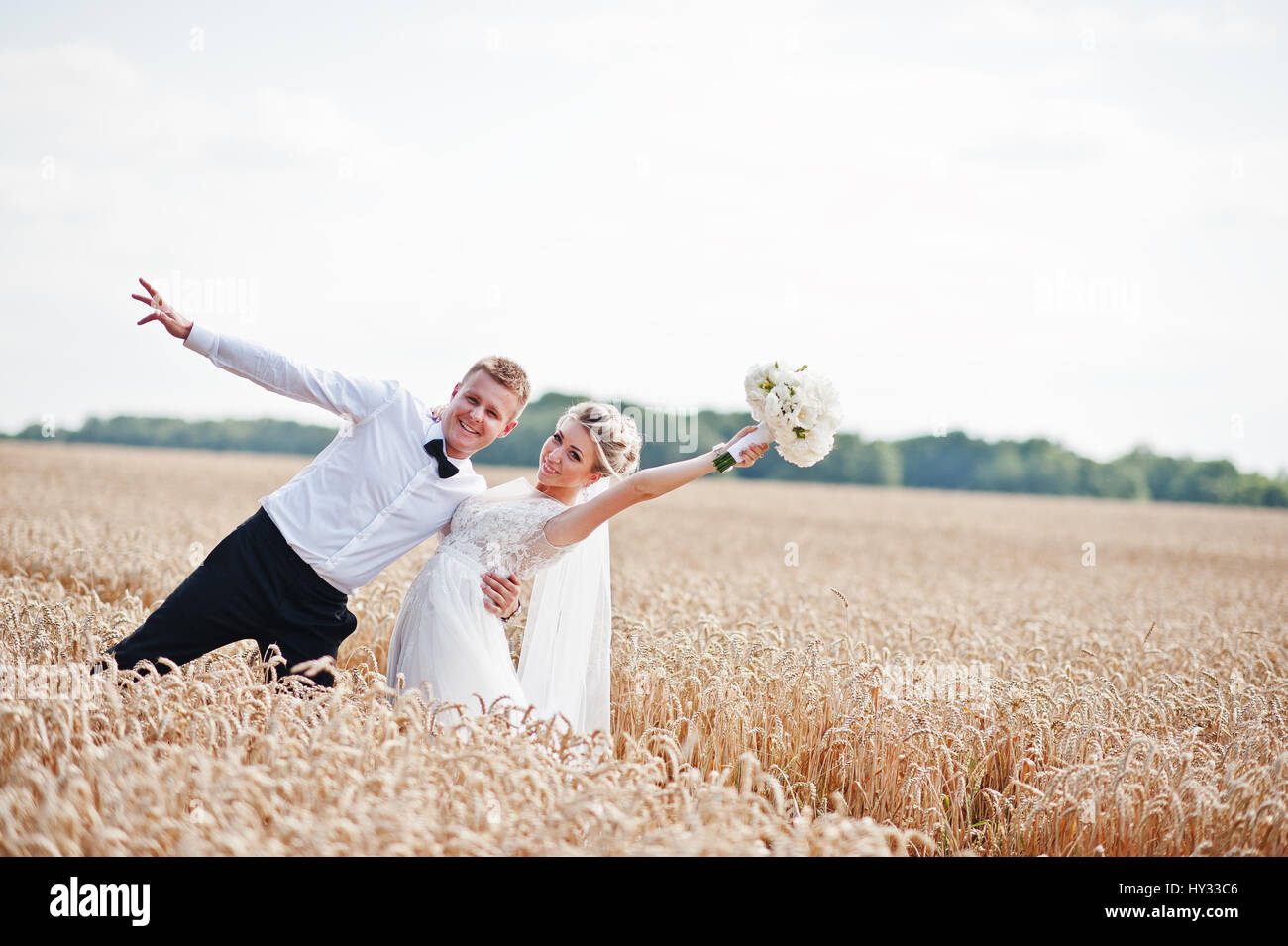 Wedding couple at field of wheat in love Stock Photo - Alamy