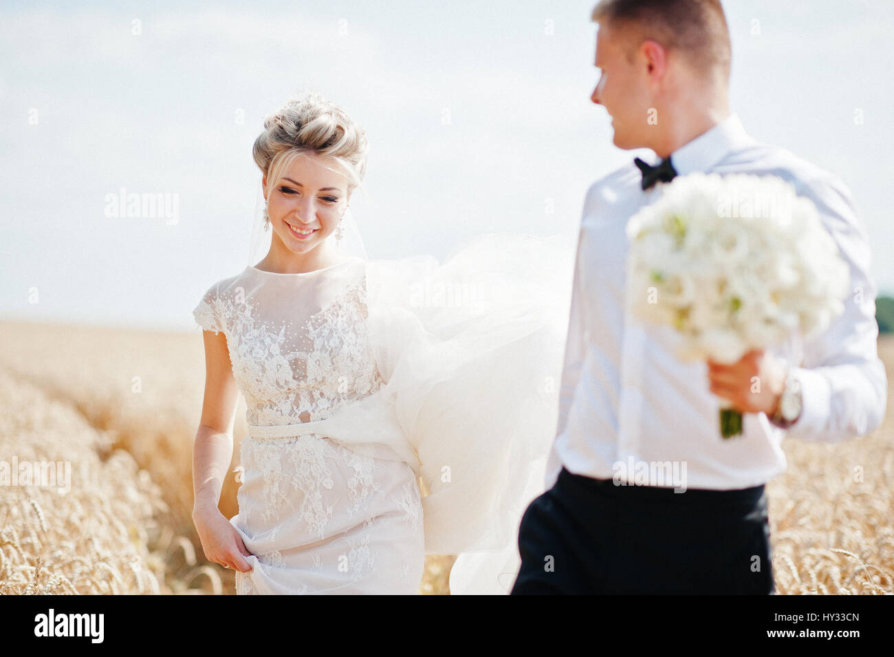Wedding couple at field of wheat in love Stock Photo - Alamy