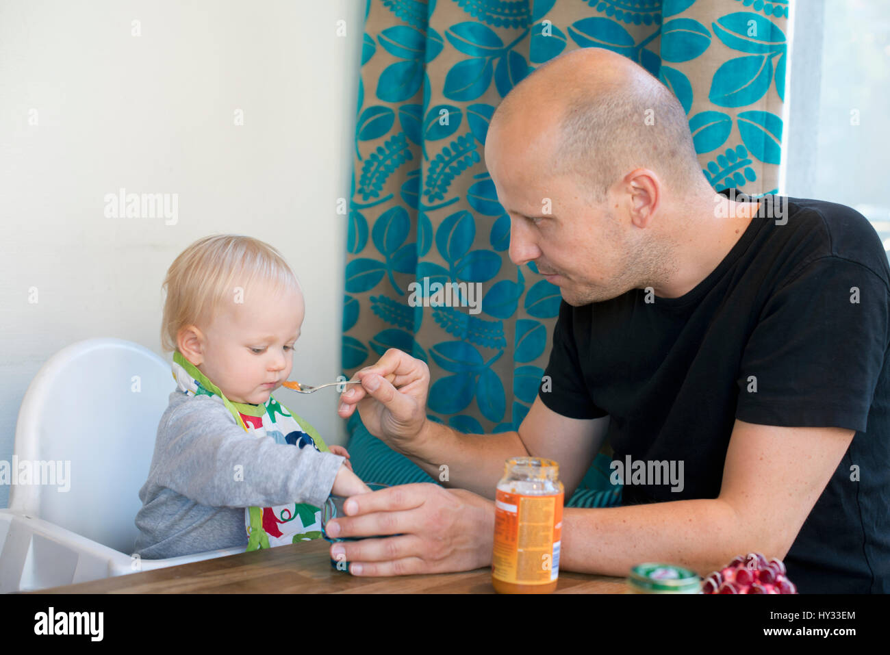 Sweden, Father feeding baby son (12-17 months Stock Photo - Alamy