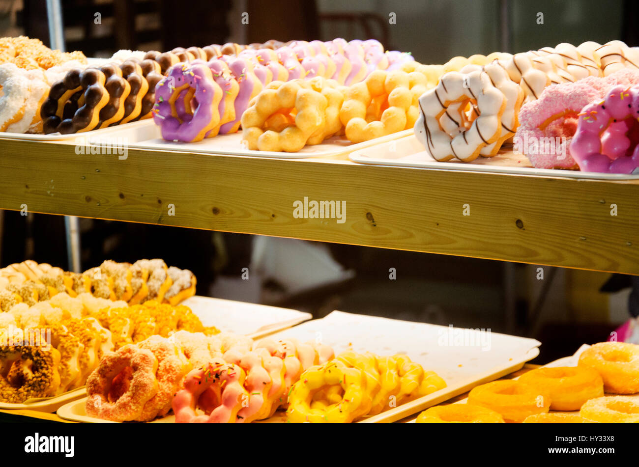 Display of delicious pastries in a bakery with assorted glazed colorful ...
