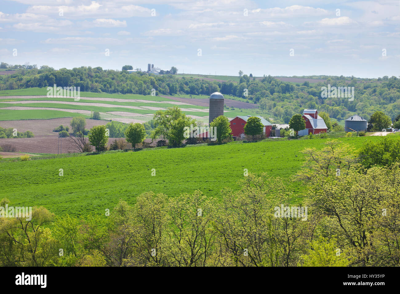 Farms on a hillside in the Iowa countryside during spring Stock Photo ...