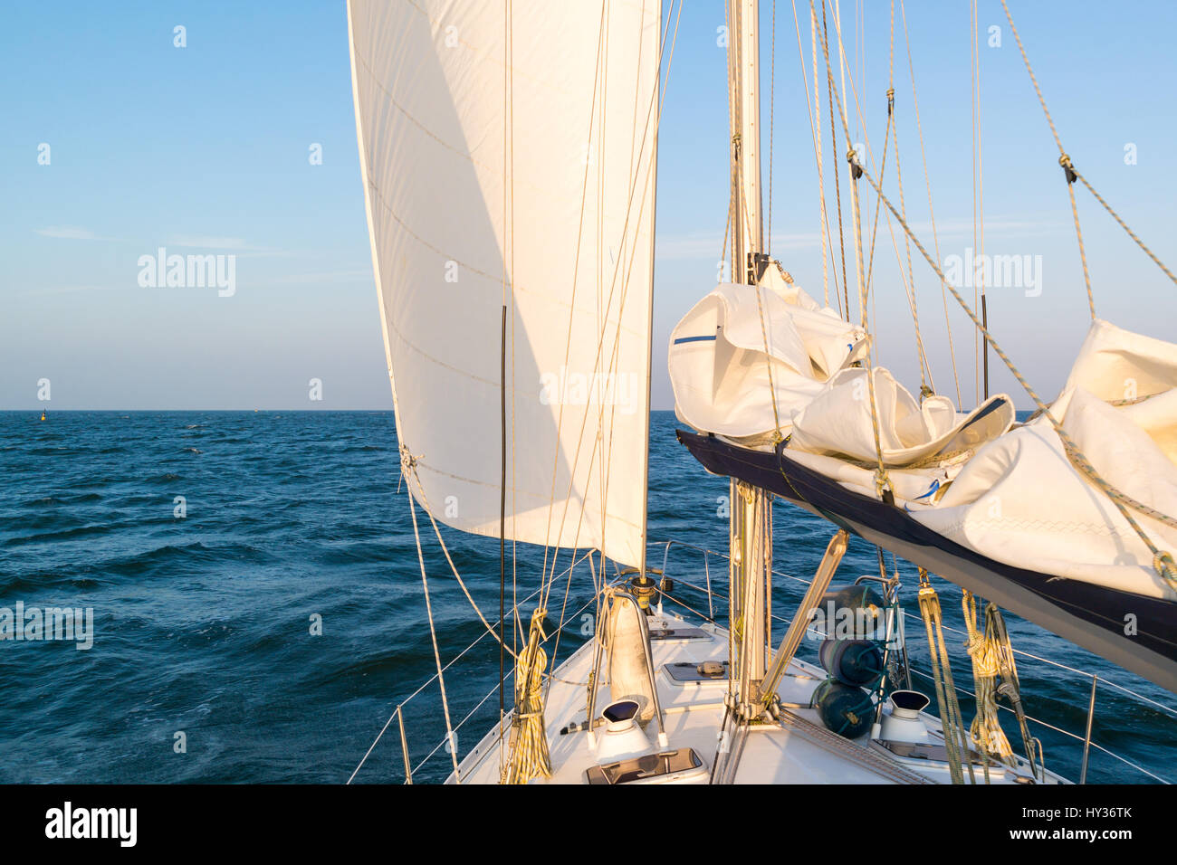Front of sailing boat with foresail cruising on calm and sunny ...