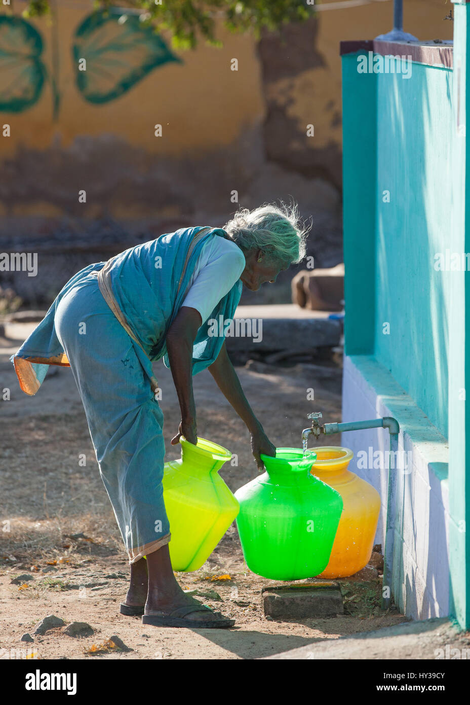 old woman filling water container,India Stock Photo - Alamy