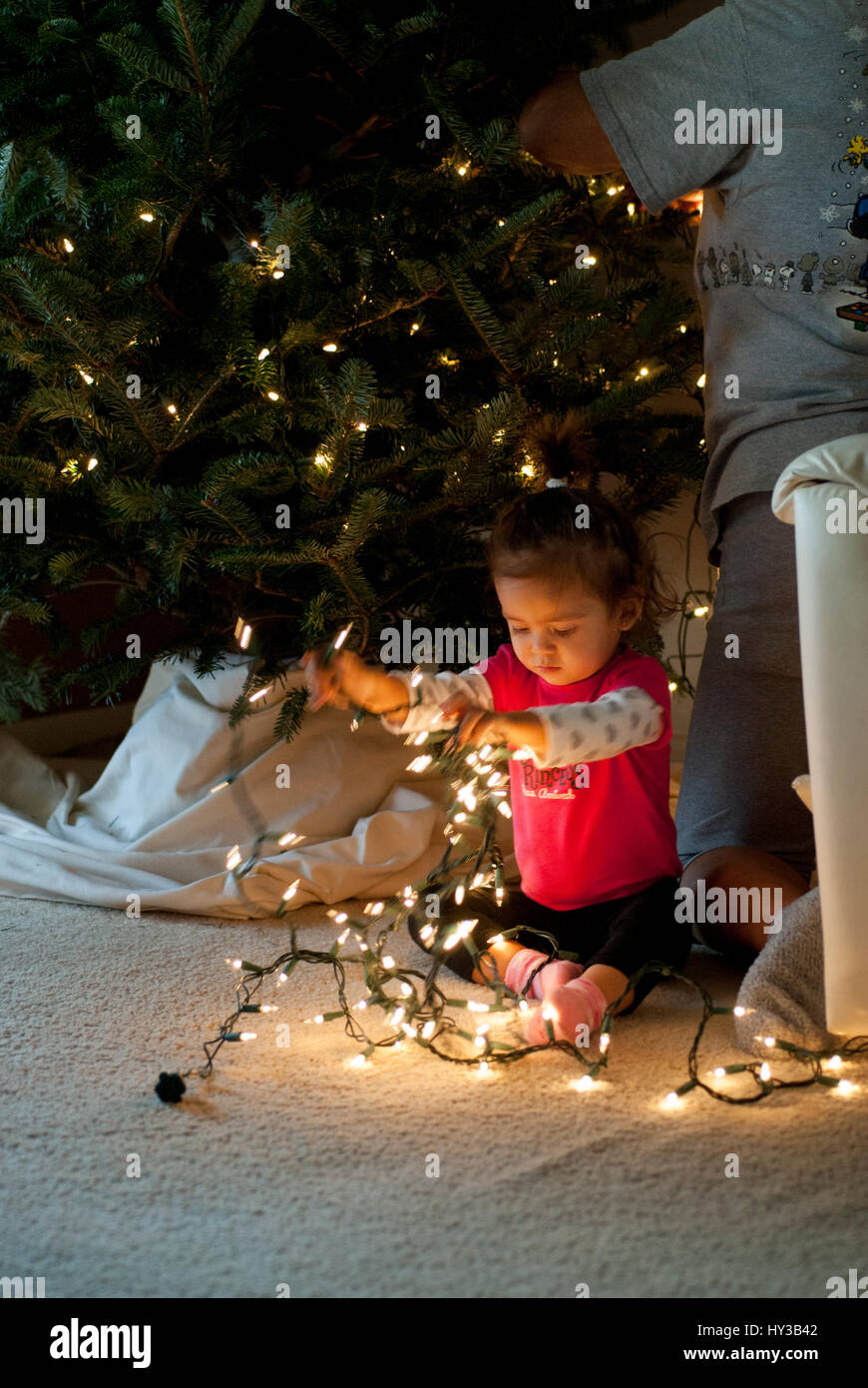 little girl Christmas with lights playing Stock Photo - Alamy