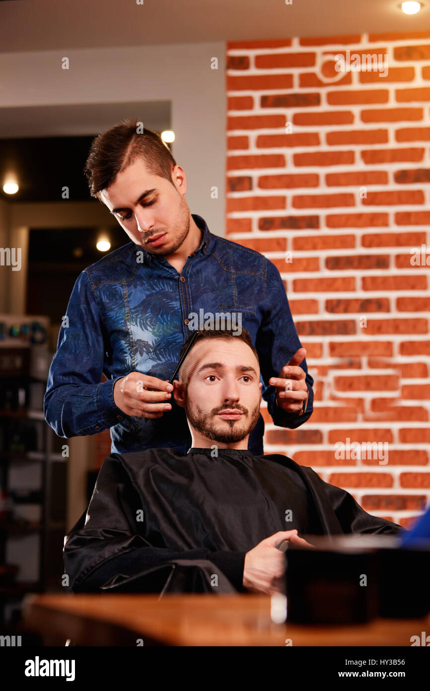 Hairdresser combing man hair in hi-res stock photography and images - Alamy
