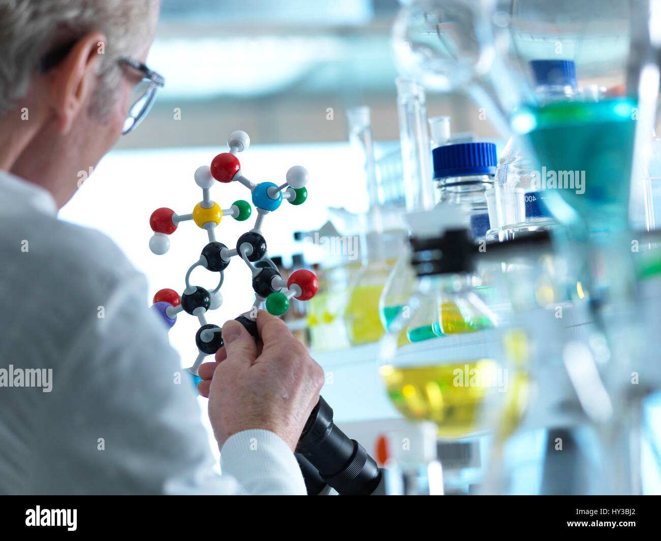 MODEL RELEASED. Scientist understanding a chemical experiment using a ...