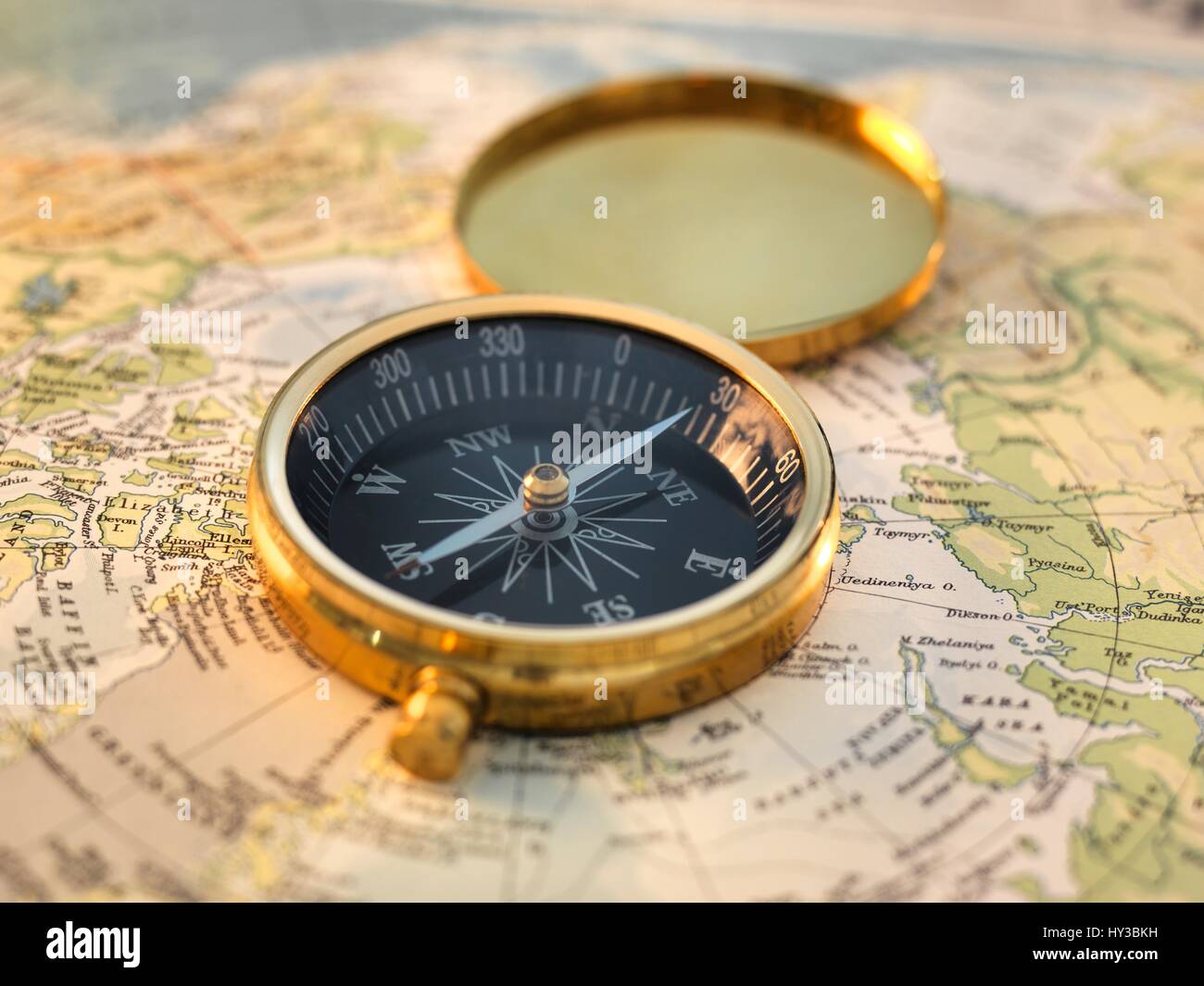 Compass sitting on a map of the artic circle Stock Photo - Alamy