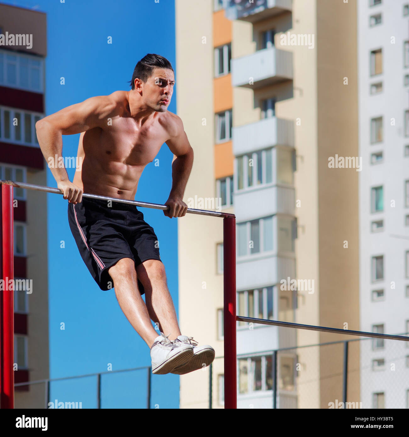 Workout, sportsman pull ups the horizontal bar with big effort Stock ...