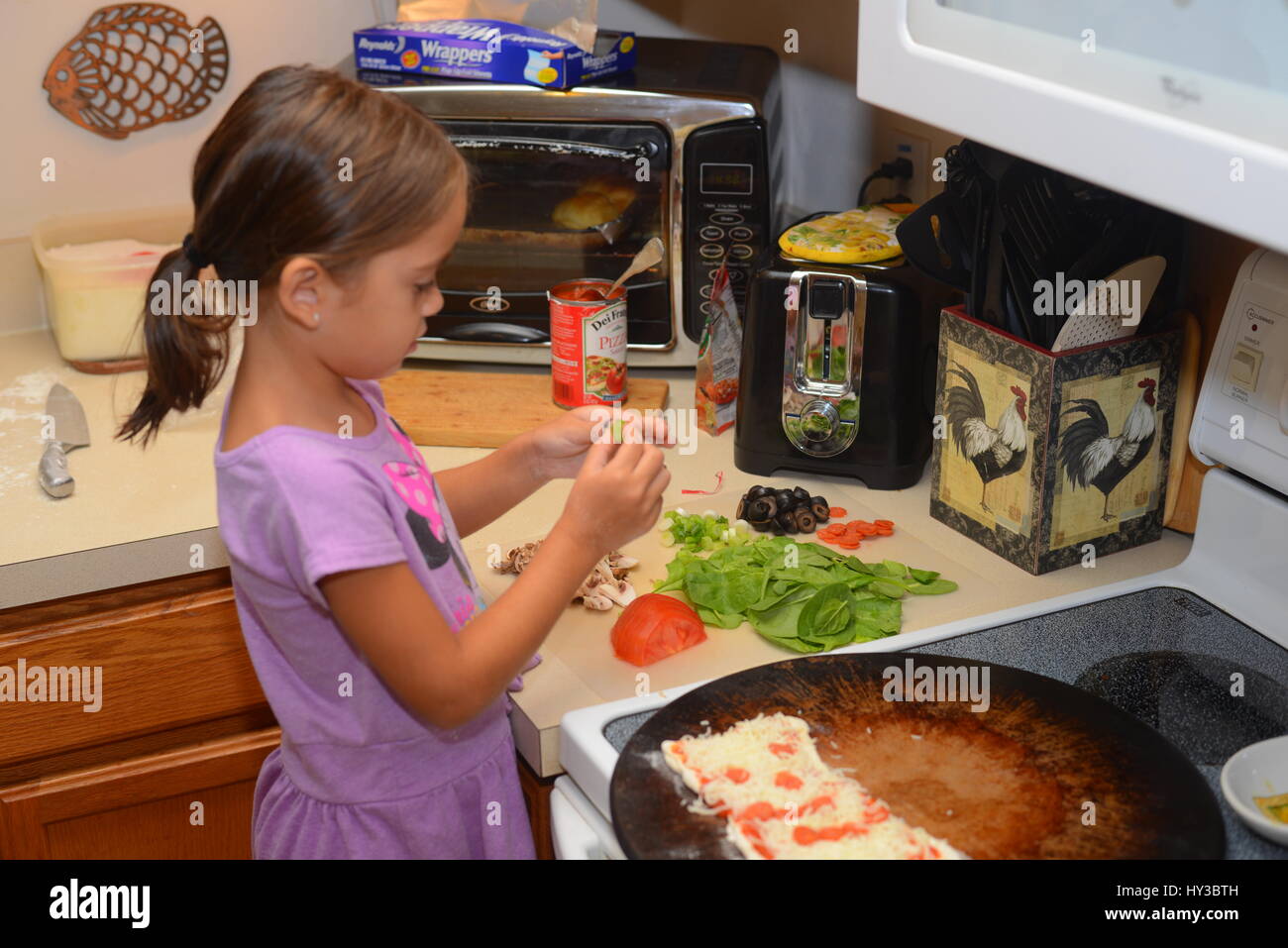 Young girl making pizza hi-res stock photography and images - Alamy