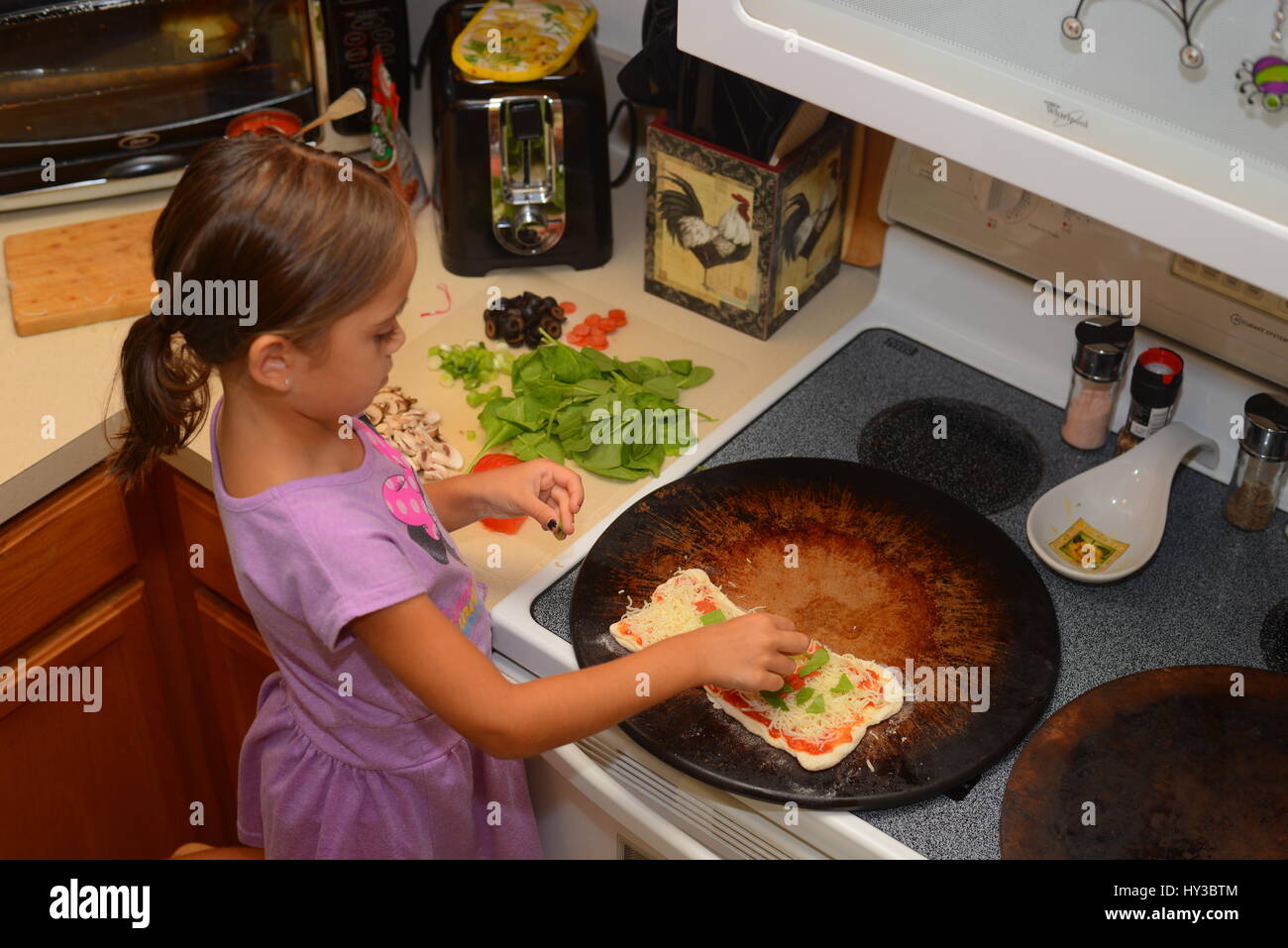young girl cooking pizza Stock Photo - Alamy