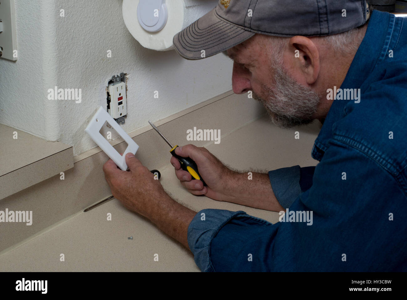 handy man with tools in kitchen electrical repair Stock Photo - Alamy