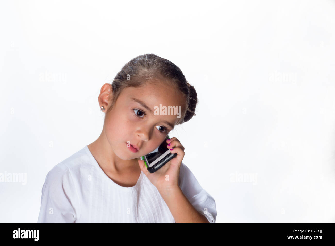 young girl in studio white on white posing with phone Stock Photo - Alamy