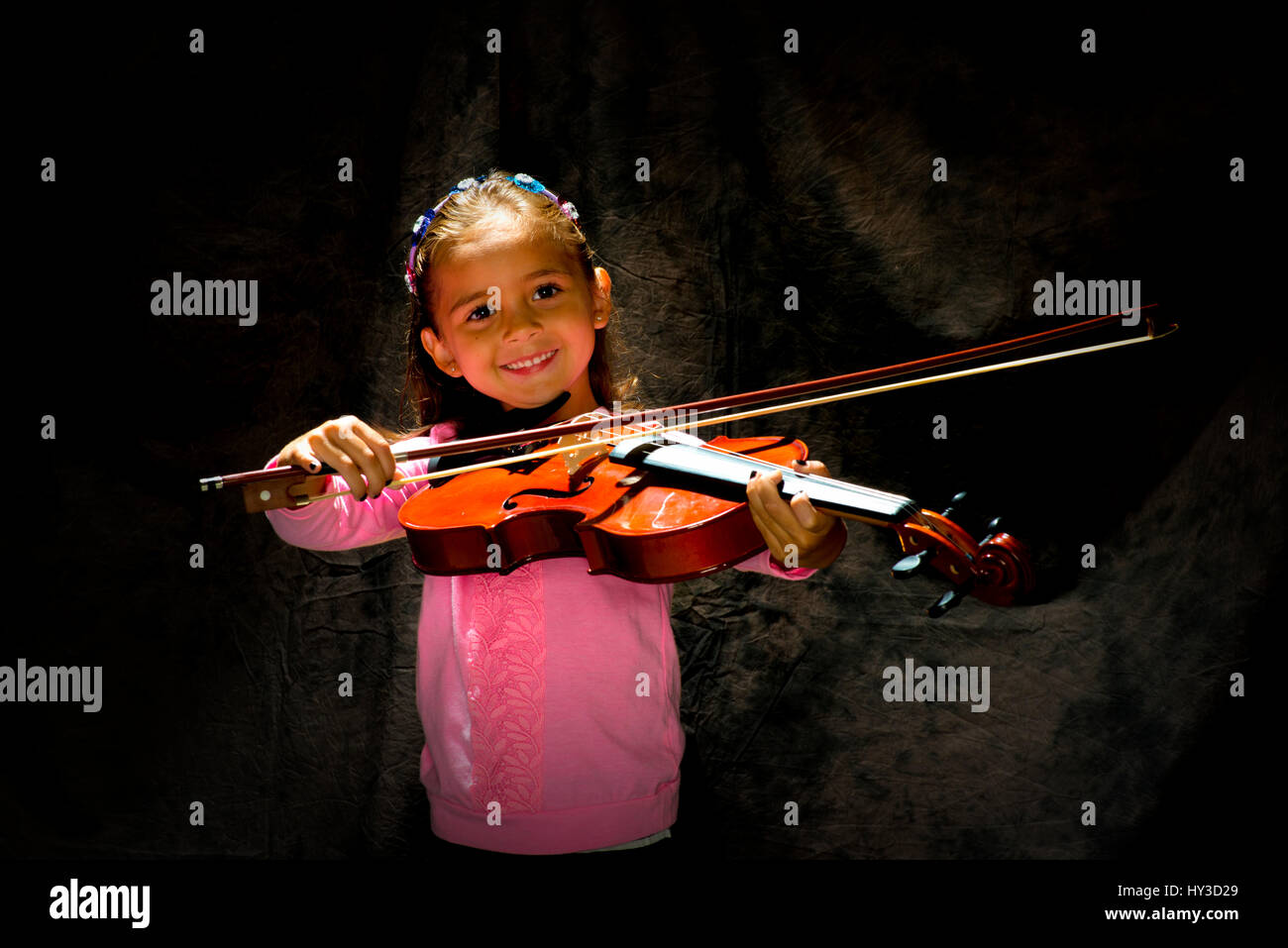 Girl playing musical instruments hi-res stock photography and images ...