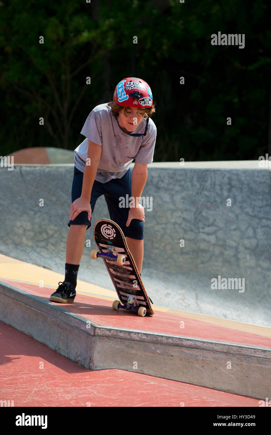young boy on skate board looking on Stock Photo - Alamy