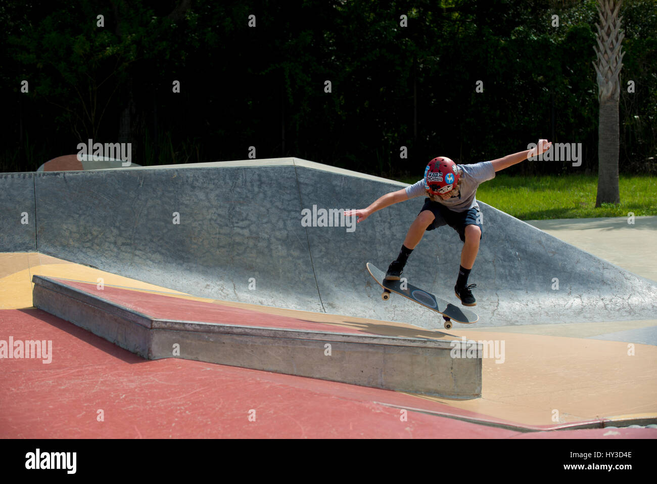 young boy on skate board jumping on concrete Stock Photo - Alamy