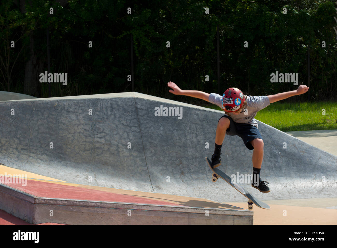young boy on skate board jumping Stock Photo - Alamy