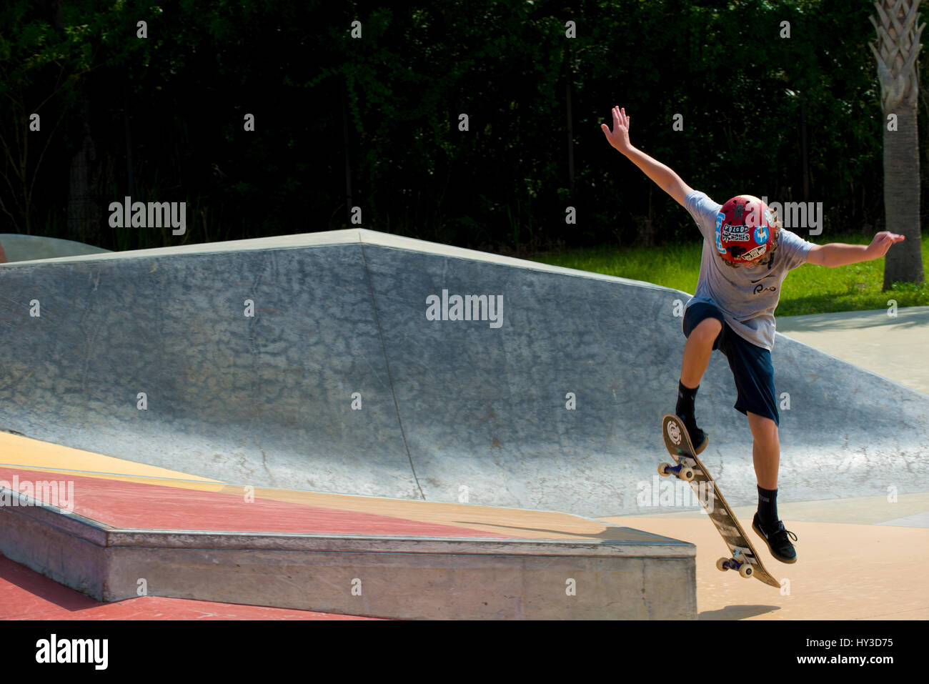 young boy on skate board jumping Stock Photo - Alamy