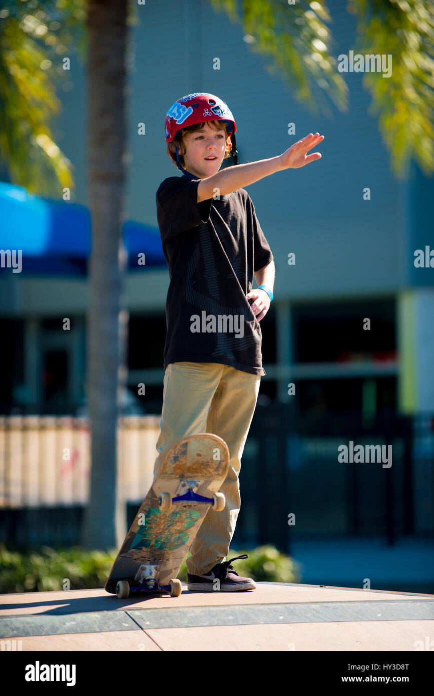 young boy on skate board showing way Stock Photo - Alamy