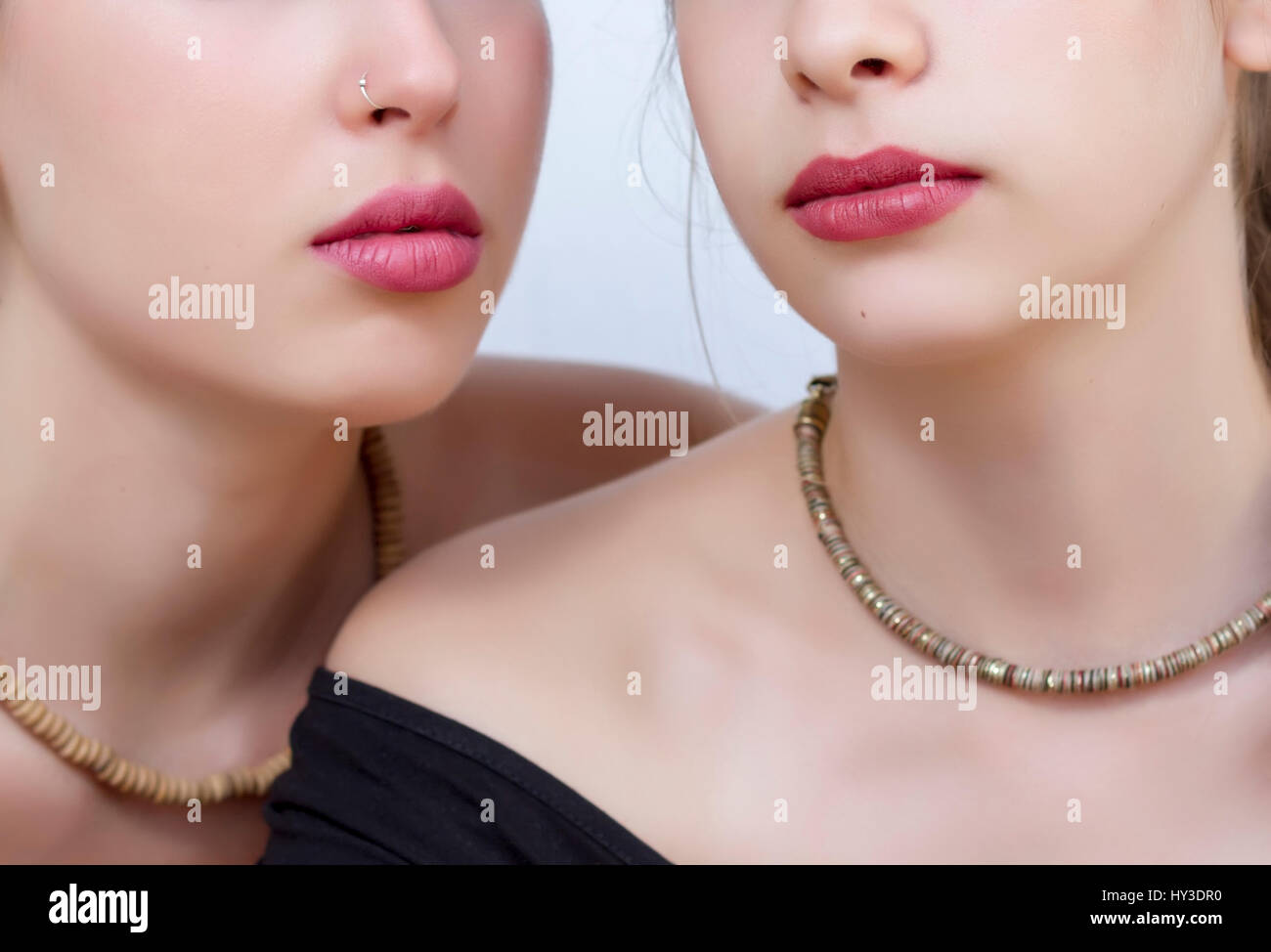 Close up of two young women lips over white background Stock Photo - Alamy
