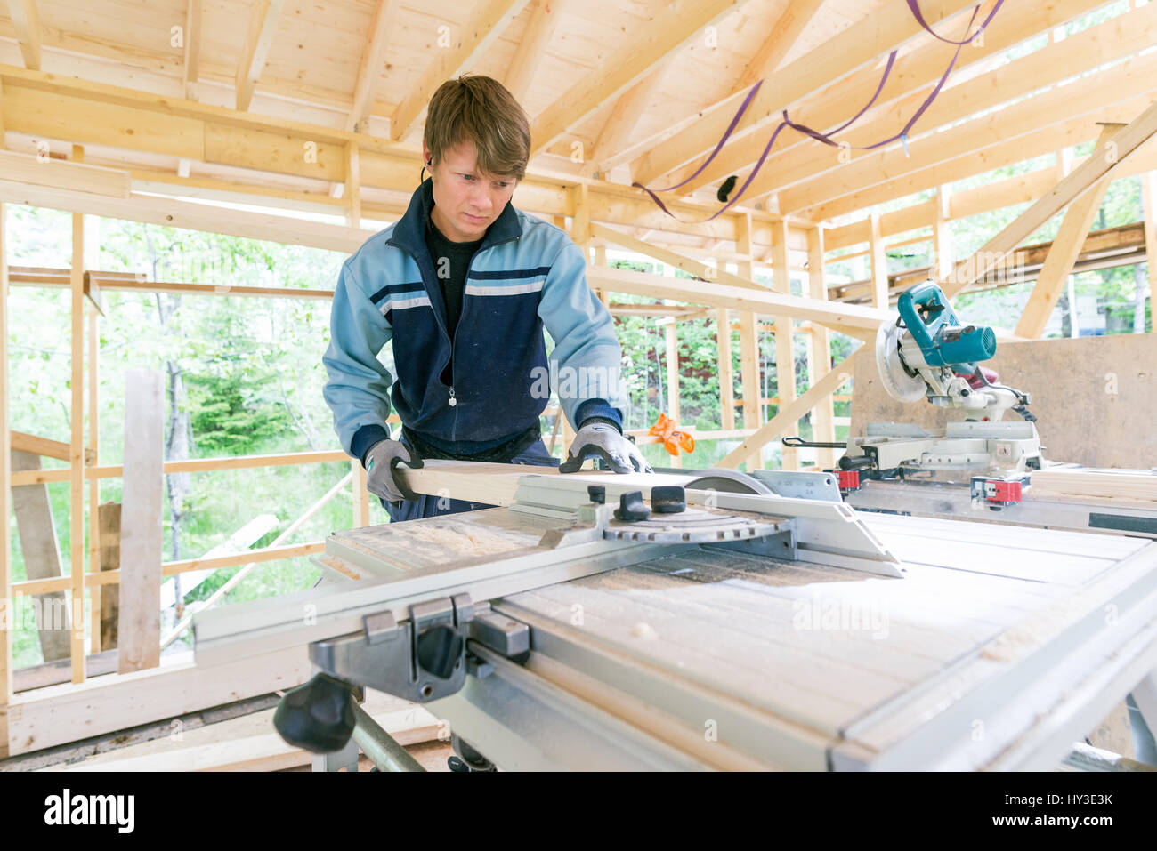 Man holding saw hi-res stock photography and images - Alamy