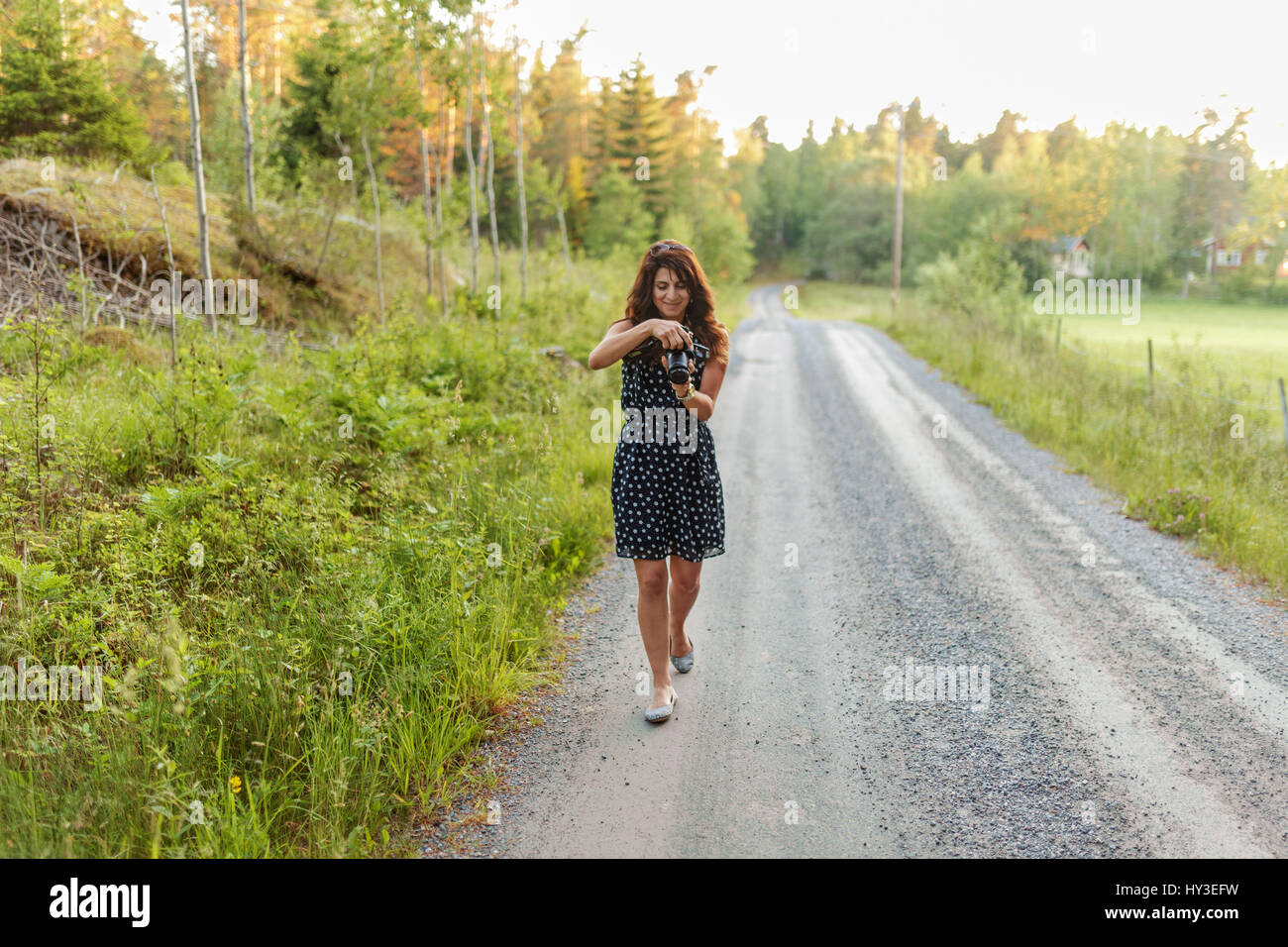 Woman walking road hi-res stock photography and images - Alamy