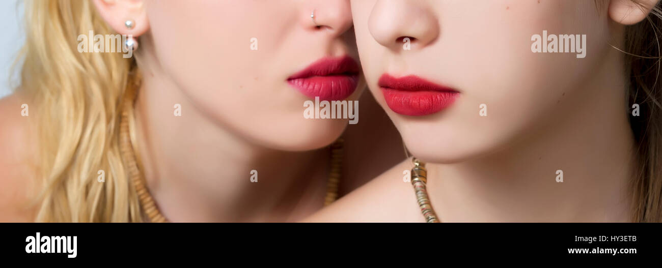 Close up of two young women lips over white background. Soft focus ...
