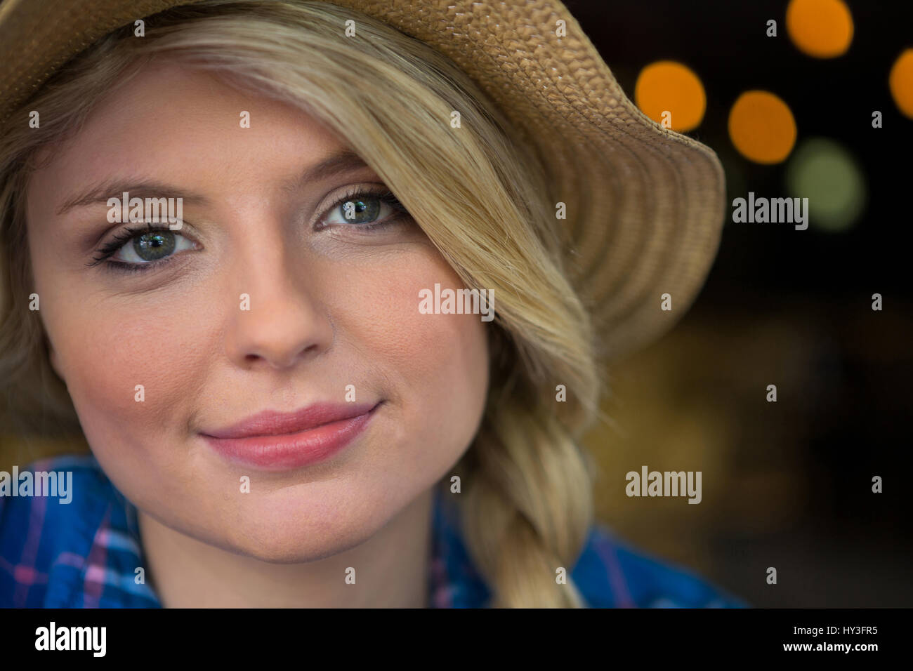Portrait of young woman wearing hat in coffee shop Stock Photo - Alamy
