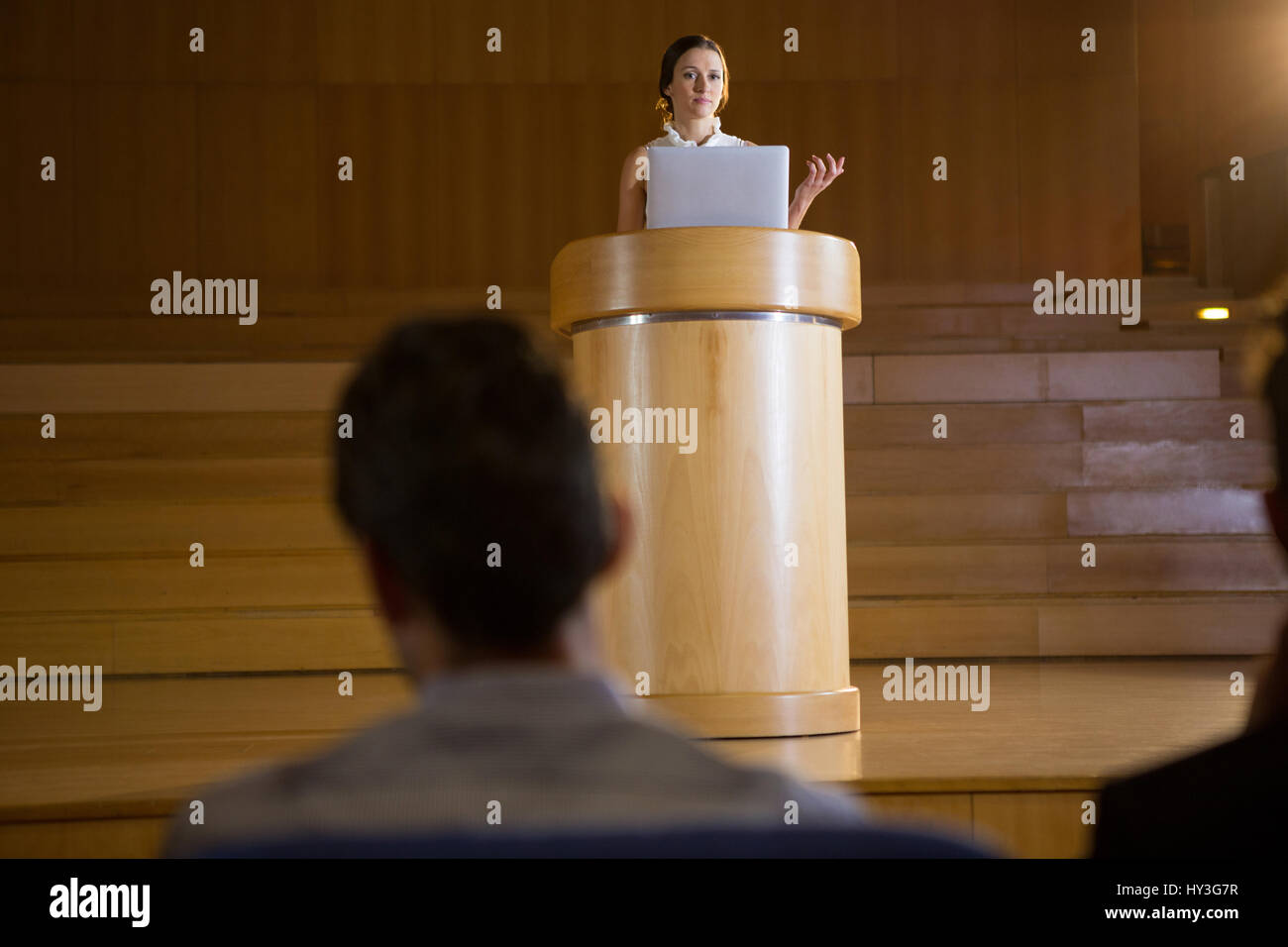 Female business executive giving a speech at conference center Stock ...