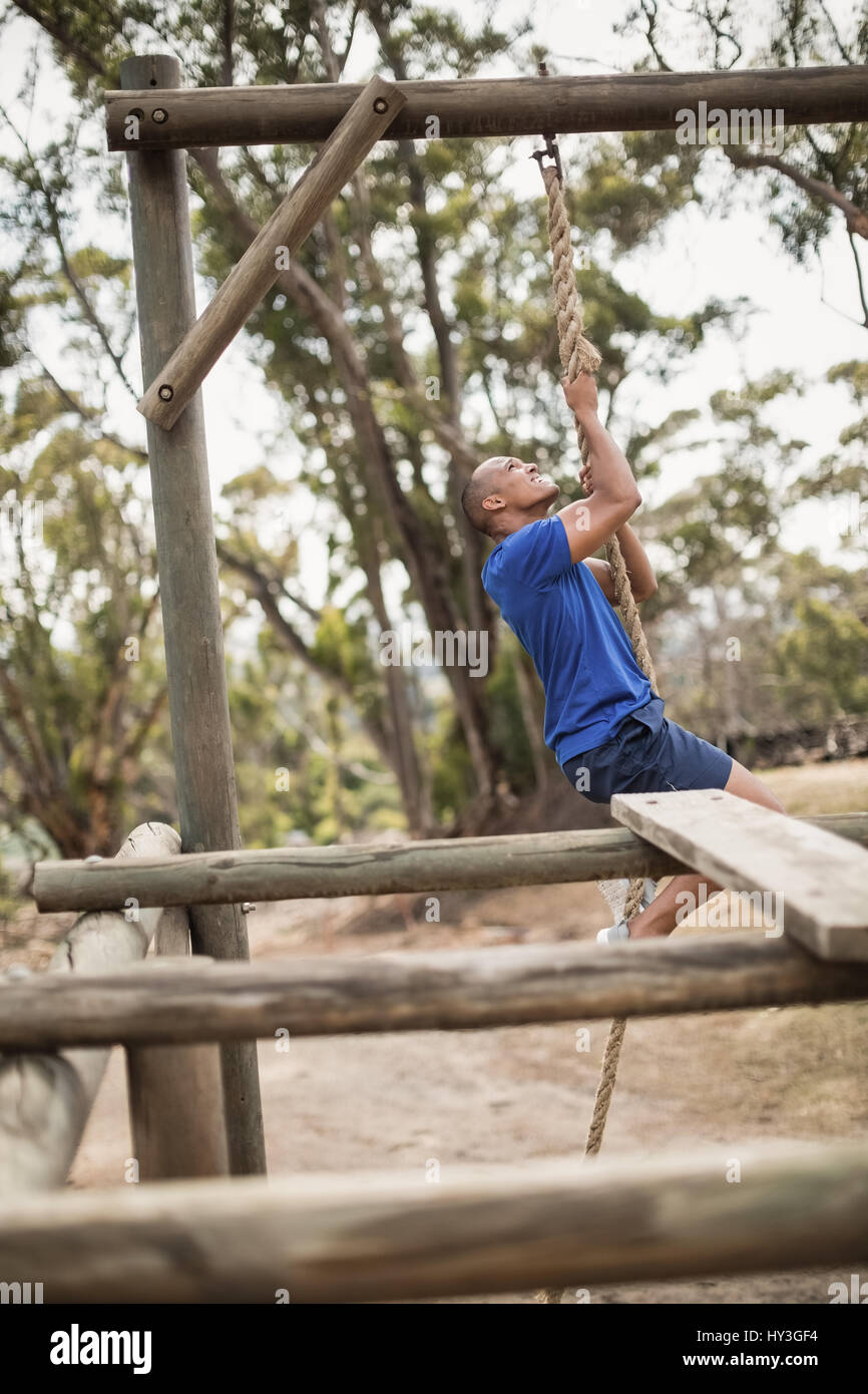 Man climbing rope during obstacle hi-res stock photography and images ...