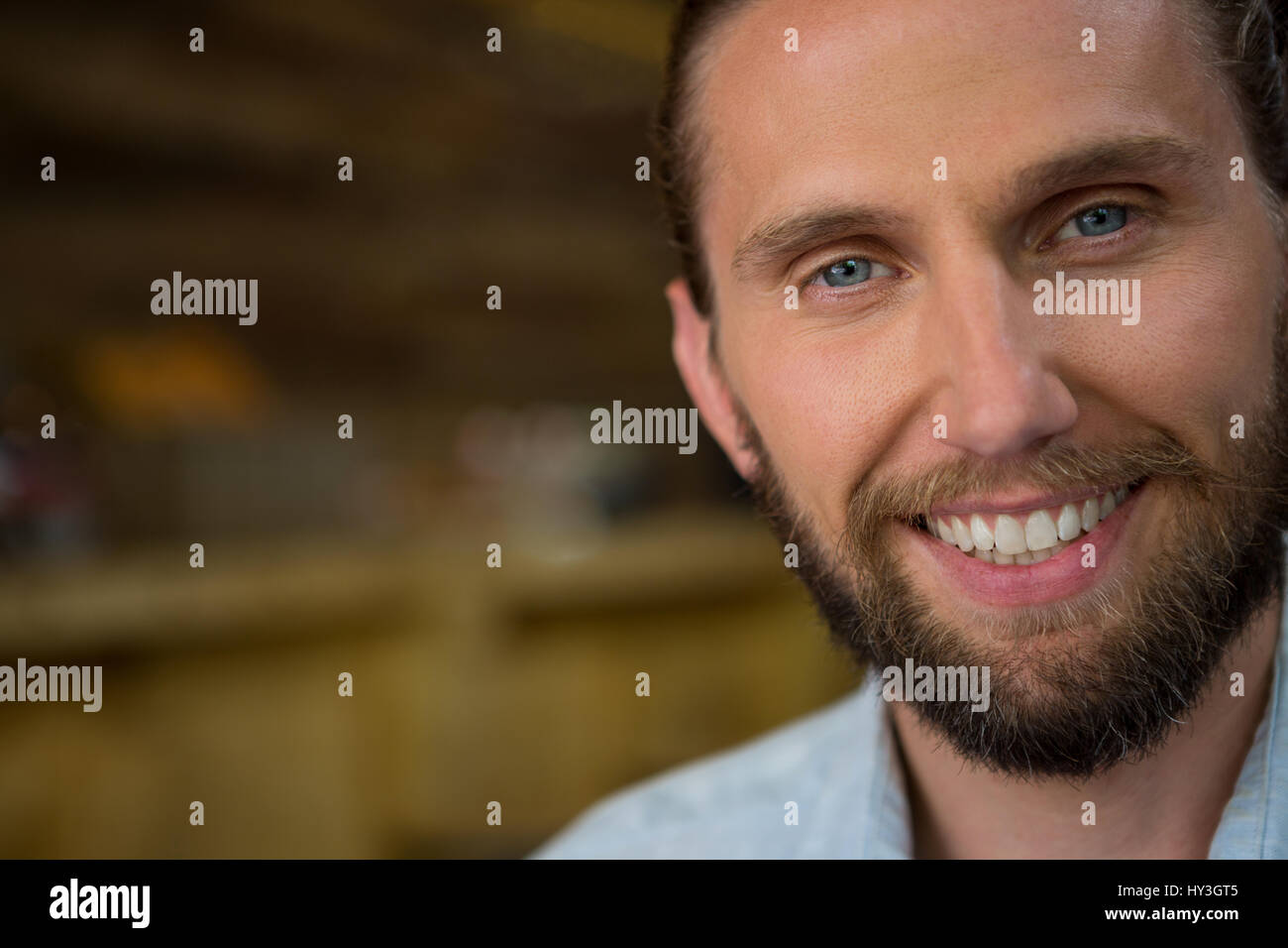 Bearded young man smiling watching hi-res stock photography and images ...