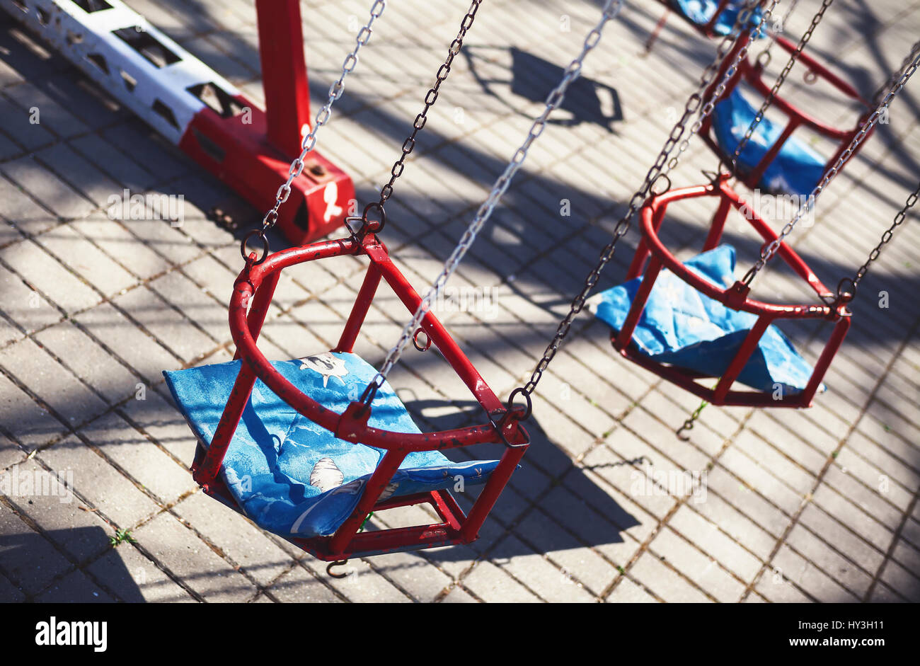 Red carousel seats, during spring sunny day Stock Photo - Alamy