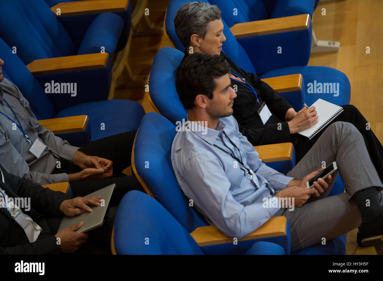 Business executive participating in a business meeting taking notes at ...