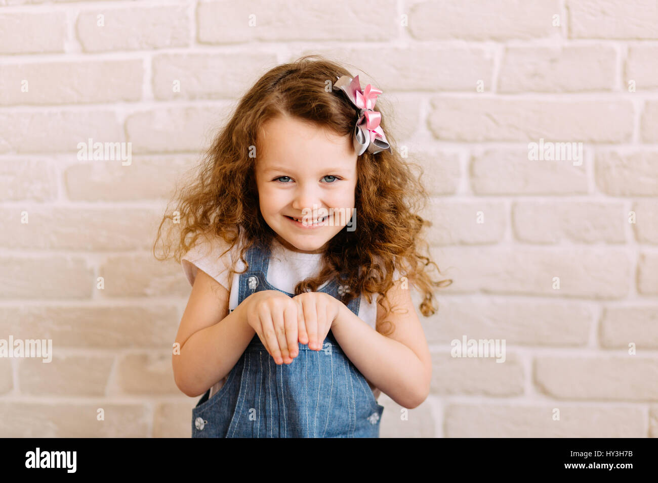 Portrait of smiling handsome naughty girl twitching and playing the ape ...