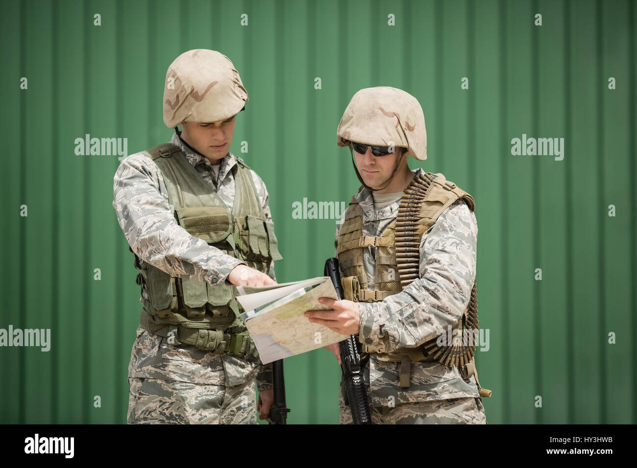 Soldiers having discussion over map in boot camp Stock Photo - Alamy