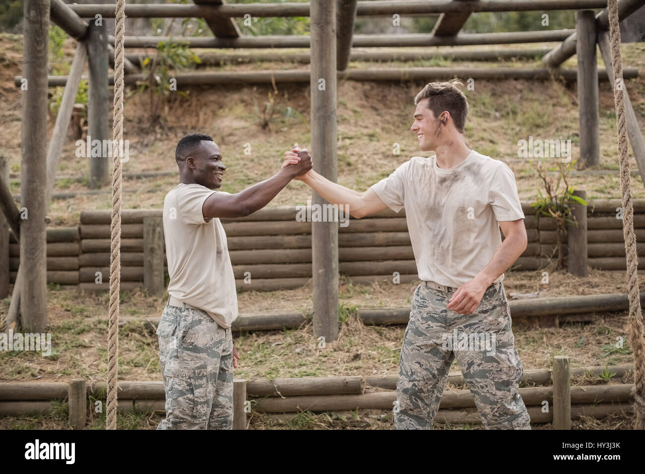 Military man greetings during obstacle course at boot camp Stock Photo ...