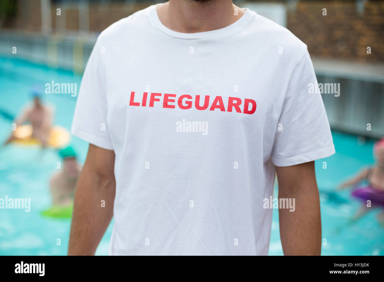 Mid section of male lifeguard standing at poolside Stock Photo - Alamy