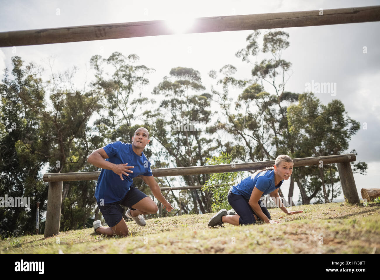People passing through hurdles during obstacle course in boot camp ...