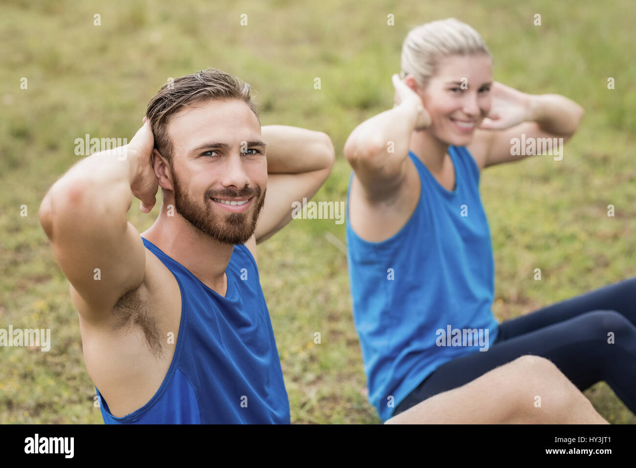 Fit people performing crunches exercise in boot camp Stock Photo - Alamy