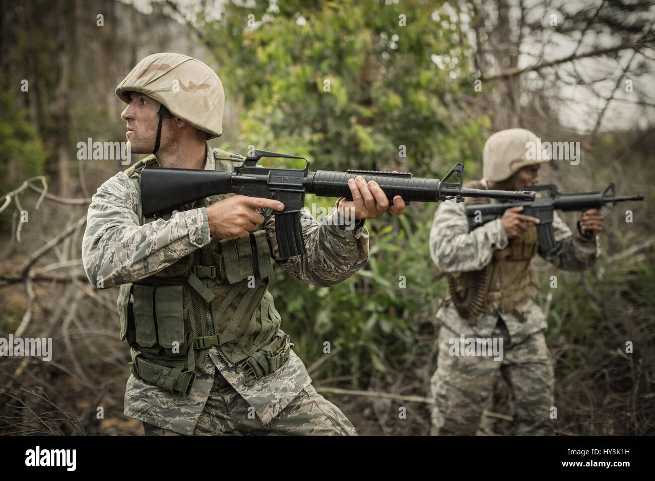 Military soldiers during training exercise with weapon at boot camp ...