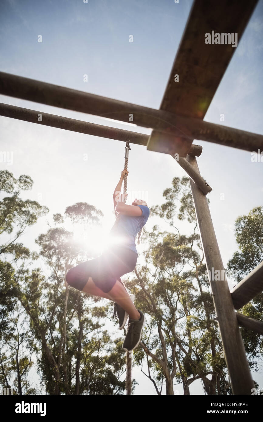 Fit woman climbing down rope hi-res stock photography and images - Alamy