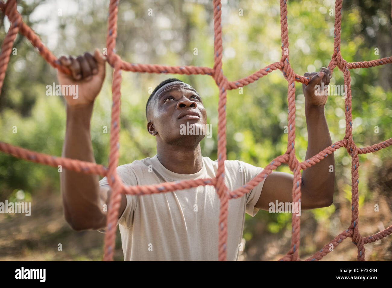 Military soldier climbing net during obstacle course in boot camp Stock ...