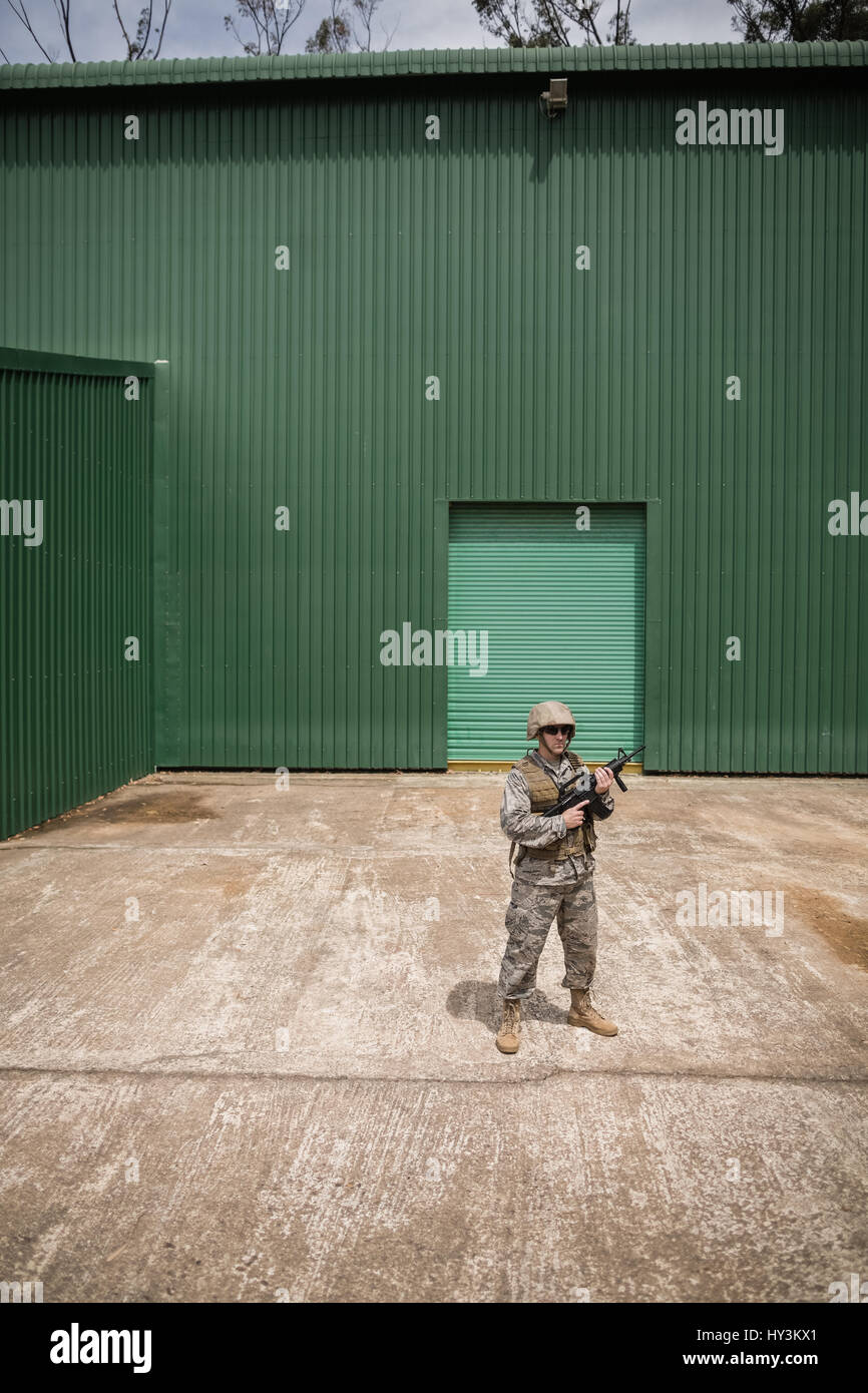 Military soldier standing with a rifle in boot camp Stock Photo - Alamy