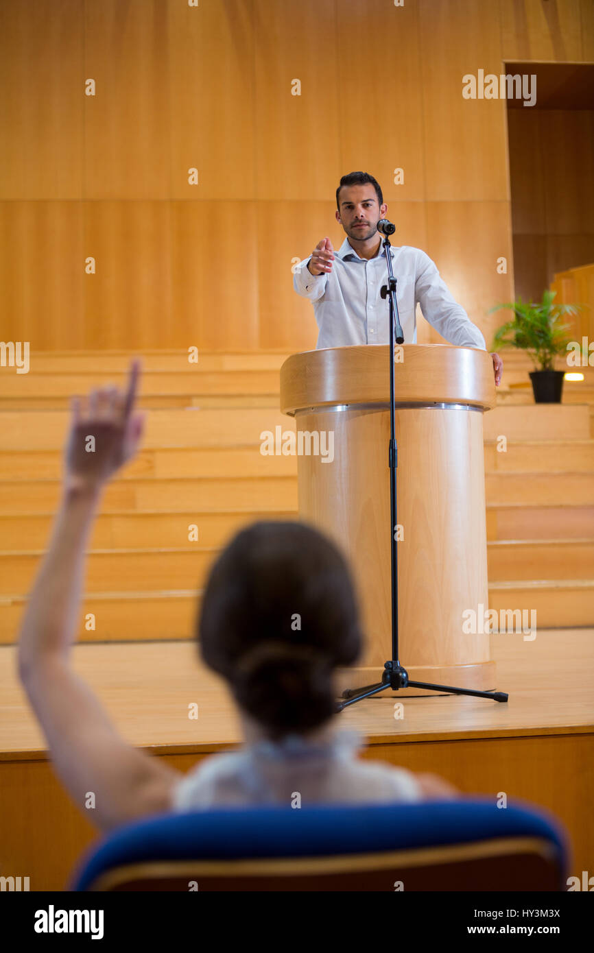 Business executive pointing towards audience while giving a speech ...