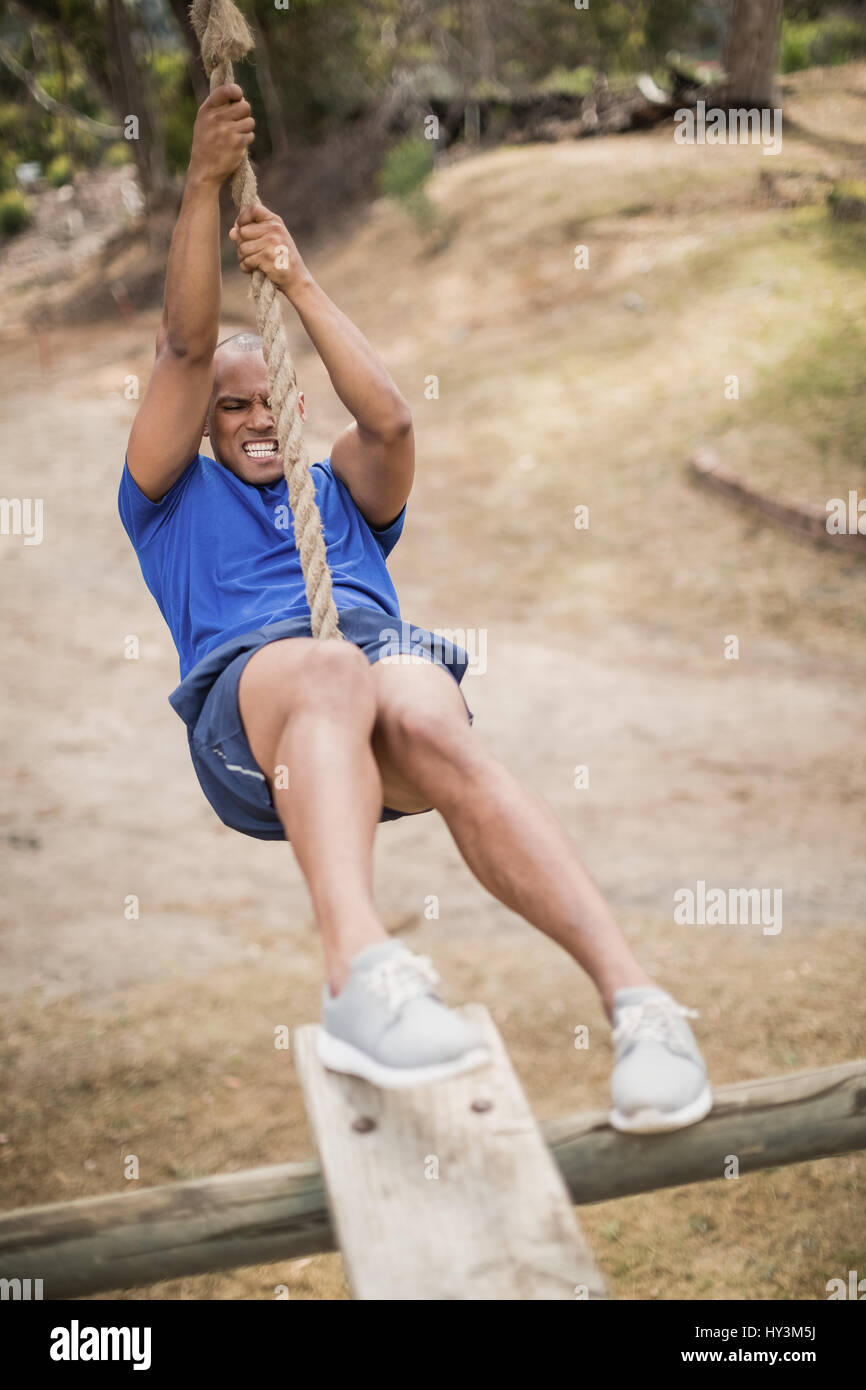Man climbing rope during obstacle hi-res stock photography and images ...