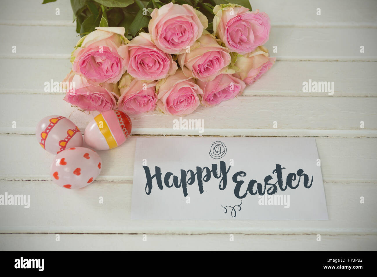 Happy easter logo against painted easter eggs with roses and envelope ...
