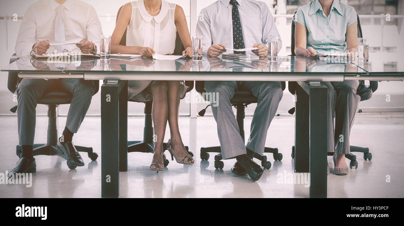 Group of business people sitting at table in office Stock Photo - Alamy