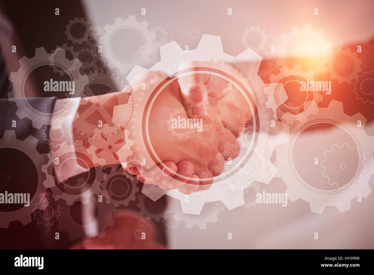 White wheels and cogs on blue against close up of business people ...