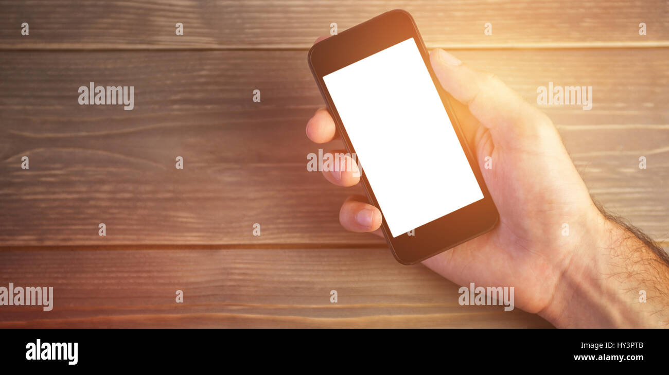 Person showing mobile phone at desk Stock Photo - Alamy